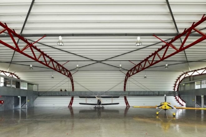 Material Efficient Plane Hangar & Museum Takes Inspiration From a Wing ...
