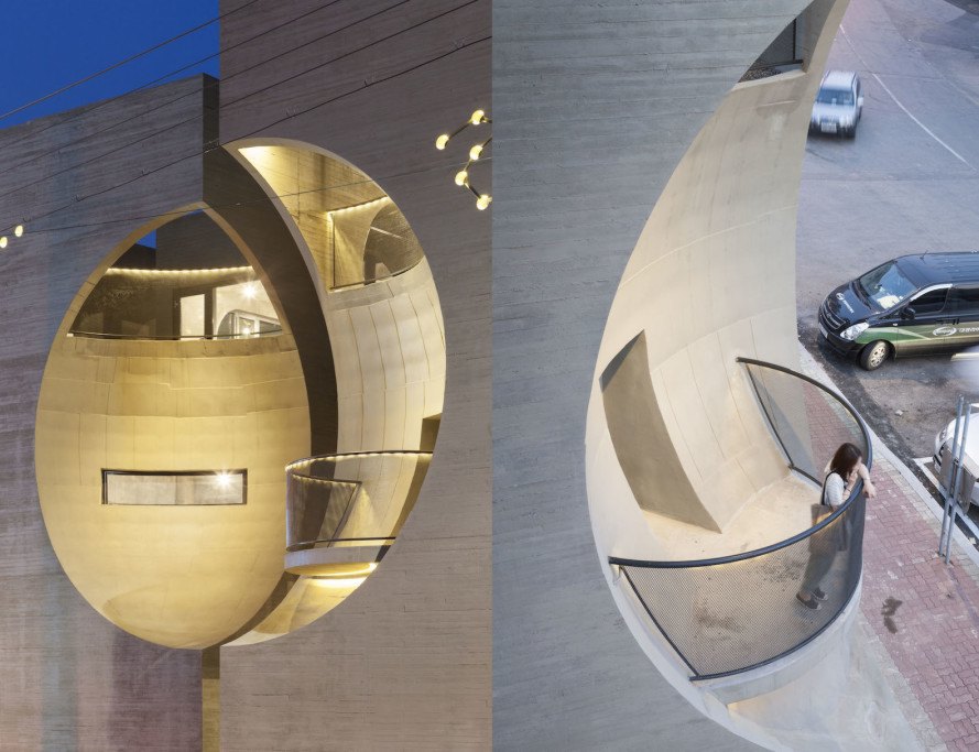 Crescent-shaped cutouts give Moon Hoon’s Two Moon building its playful edge