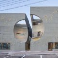 Crescent-shaped cutouts give Moon Hoon’s Two Moon building its playful edge