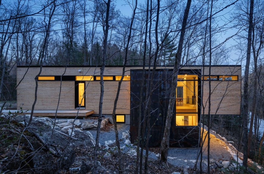 Cantilevered timber-clad retreat overlooks lakeside views in Canada