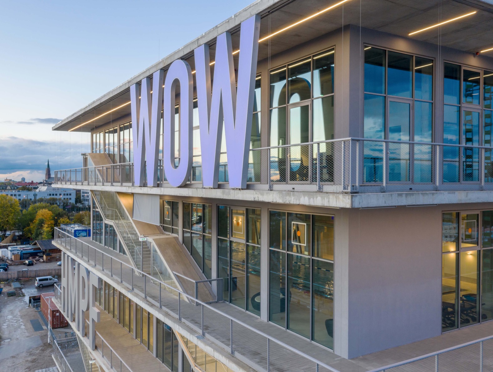 Giant glowing letters wrap MVRDV's bold WERK12 building in Munich